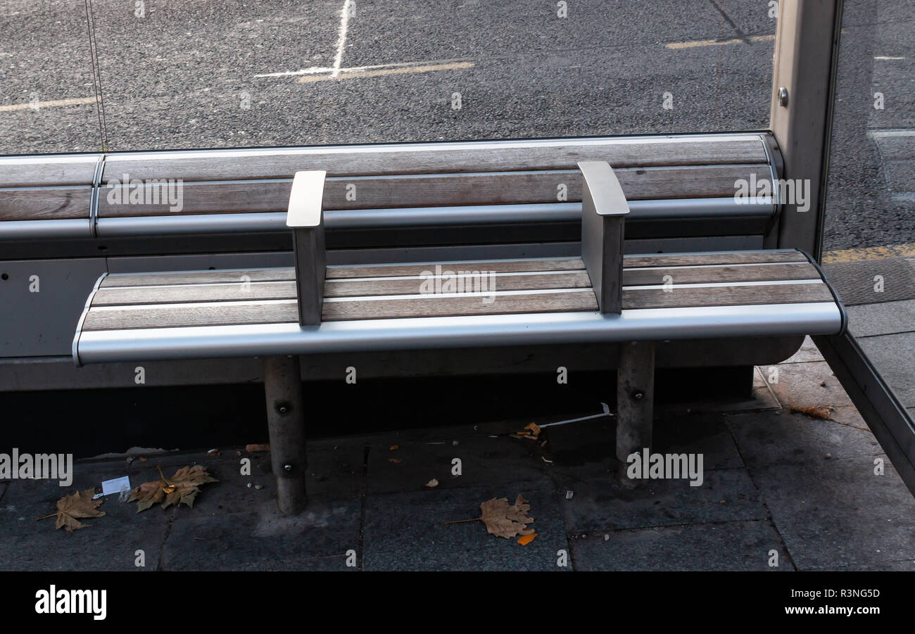 A modern wooden and metal bench inside a bus stop Stock Photo - Alamy