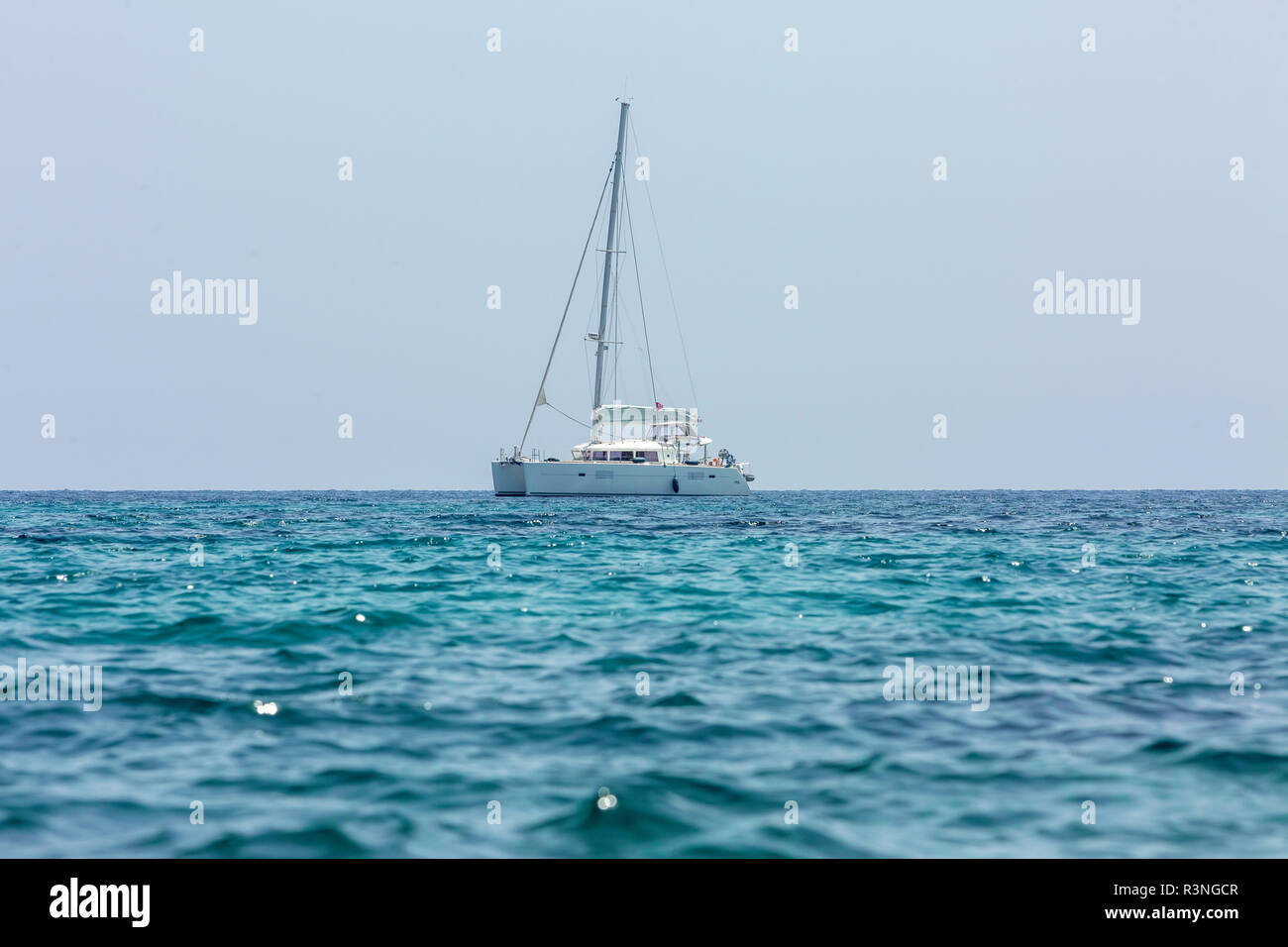 A single catamaran in the open sea. Sailboat in the Mediterranean Sea ...