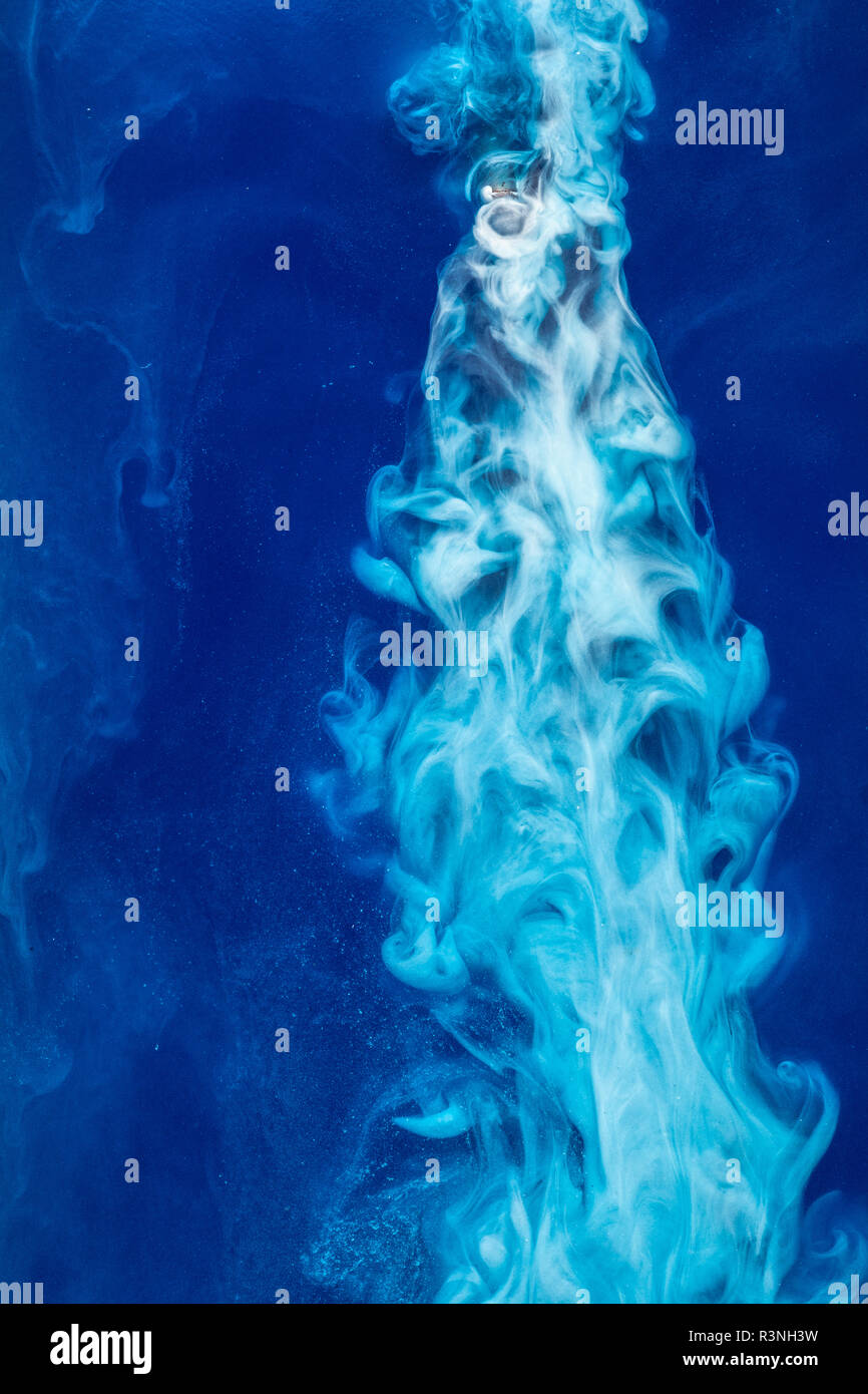 Abstract pattern falling into the water drop of blue ink - cyan ink ...