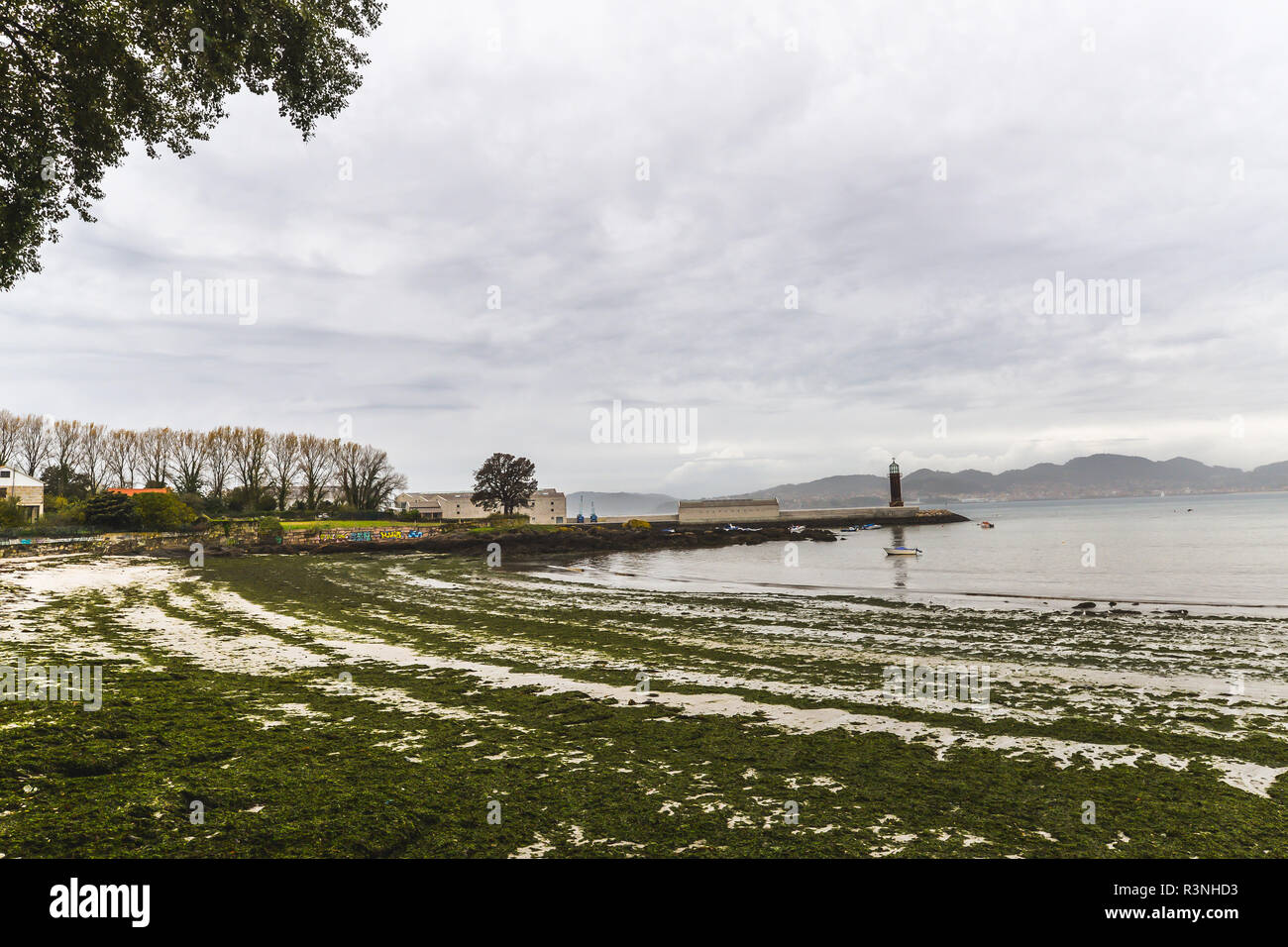 A beach and lighthouse outside of Bouzas - Vigo - Galicia - Spain Stock ...