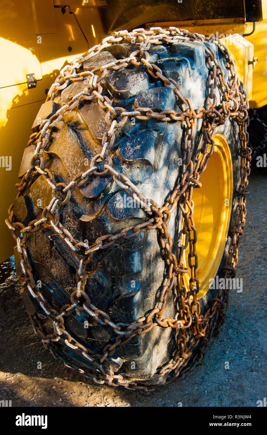 Large wheel of a tractor with mounted snow chains Stock Photo - Alamy