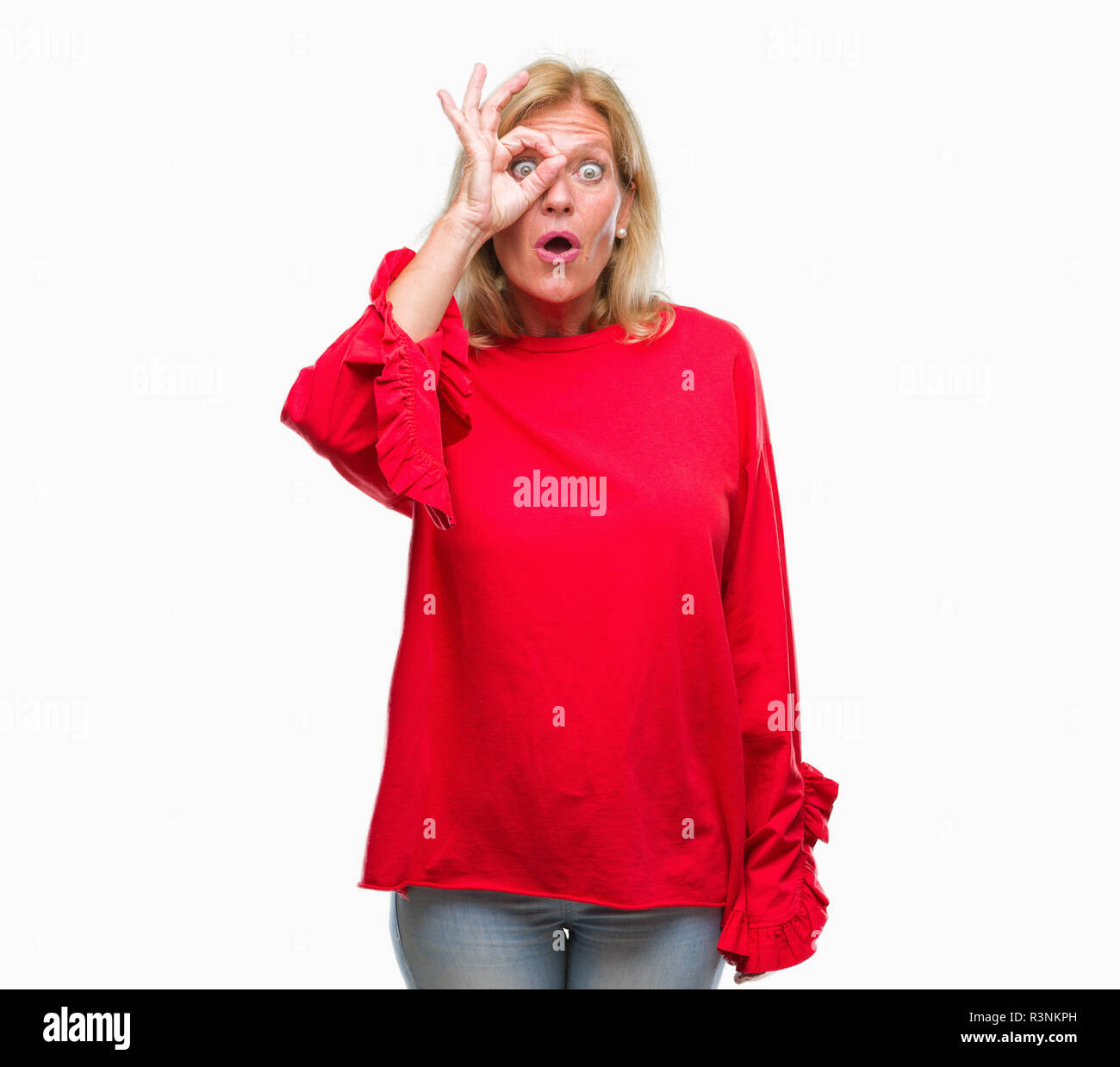 Middle age blonde woman over isolated background doing ok gesture ...