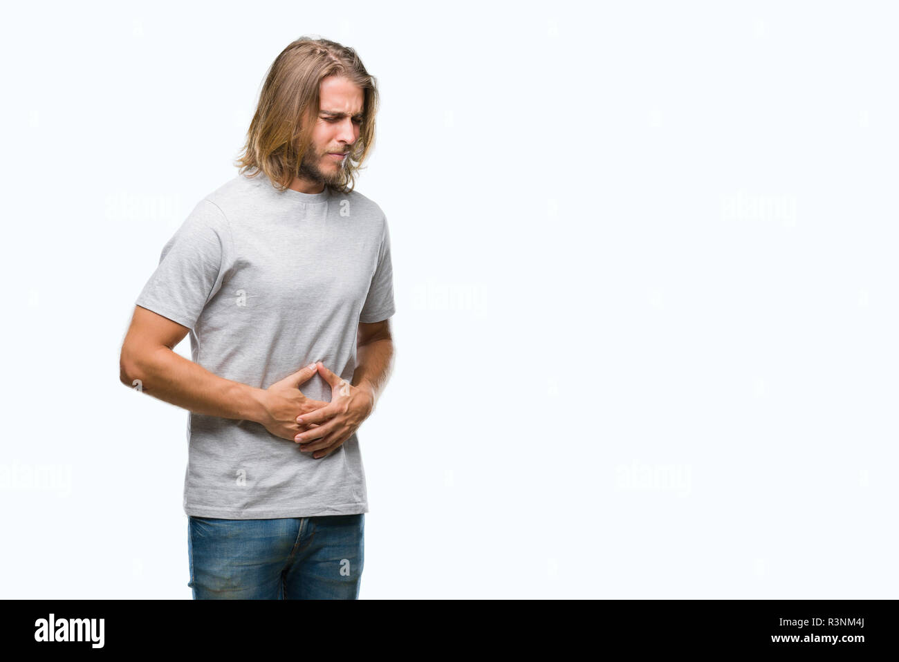 Young handsome man with long hair over isolated background with hand on ...