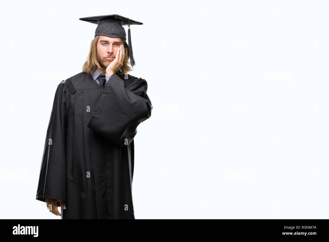 Young handsome graduated man with long hair over isolated background ...