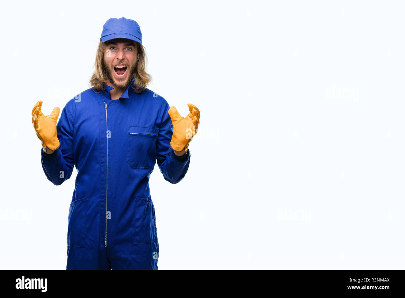 Young handsome mechanic man with long hair over isolated background ...