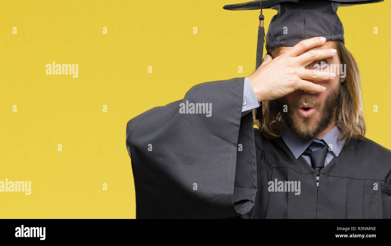 Young handsome graduated man with long hair over isolated background ...