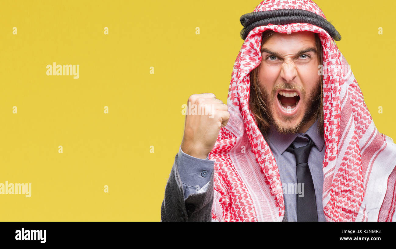 Young handsome arabian man with long hair wearing keffiyeh over ...