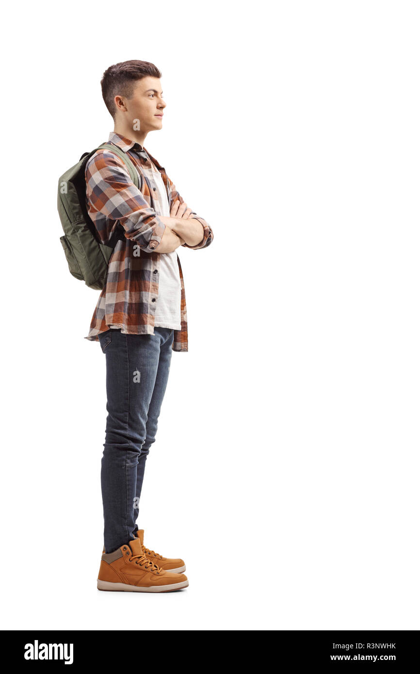 Full length profile shot of a teenage male student standing and waiting ...