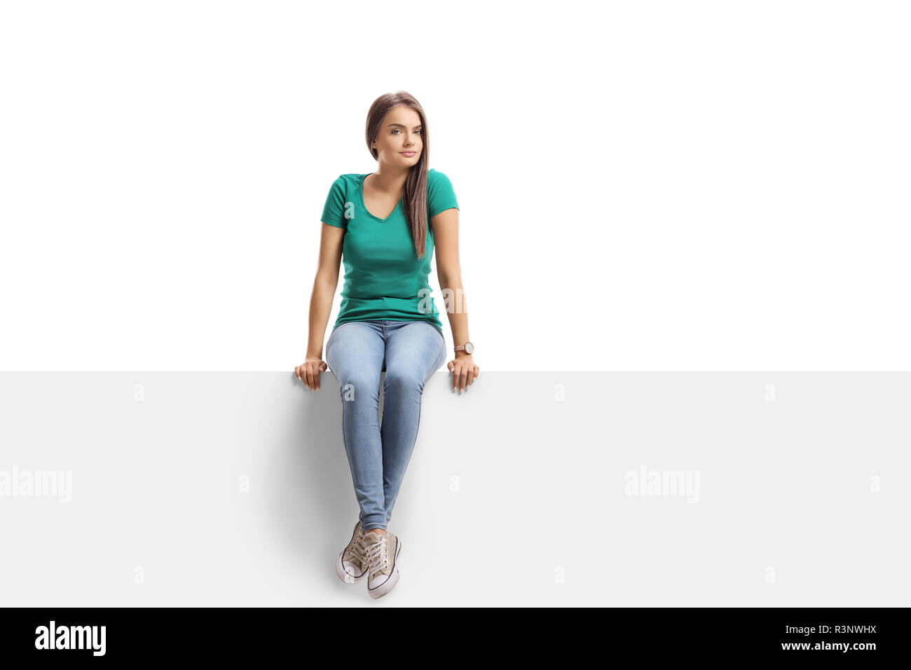 Beautiful young female sitting at a panel isolated on white background ...