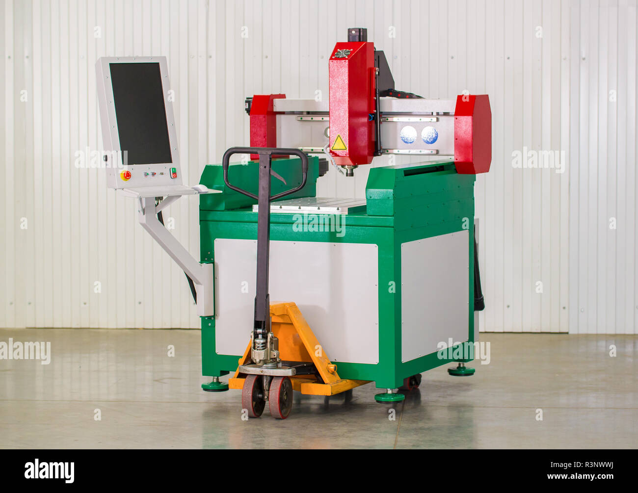 Industrial laser cutter with sparks on hydraulic trolley. The ...