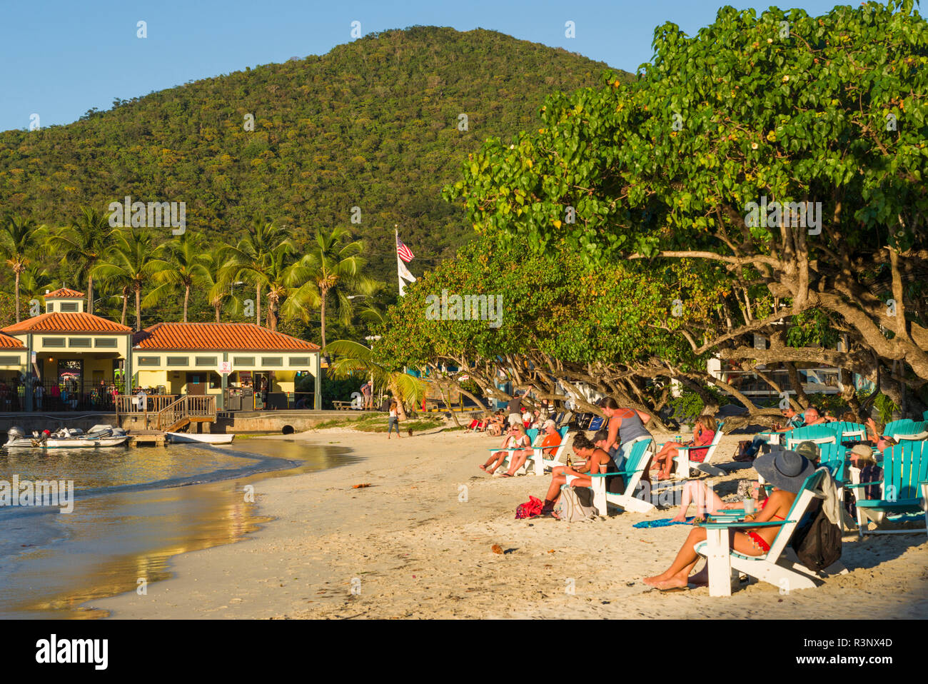 U.S. Virgin Islands, St. John. Sunset at Cruz Bay Beach with people ...
