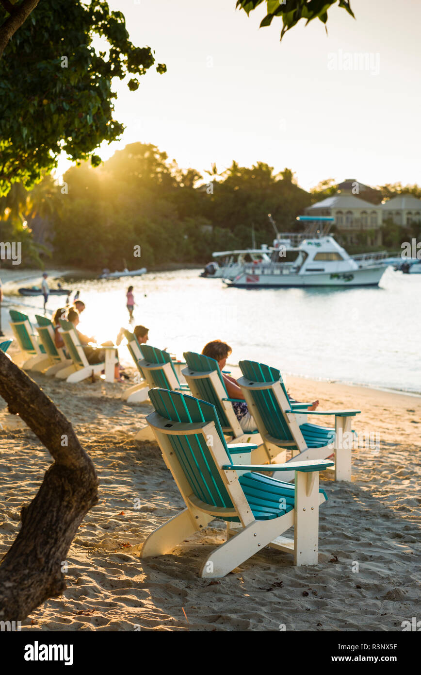 U.S. Virgin Islands, St. John. Sunset at Cruz Bay Beach with people ...