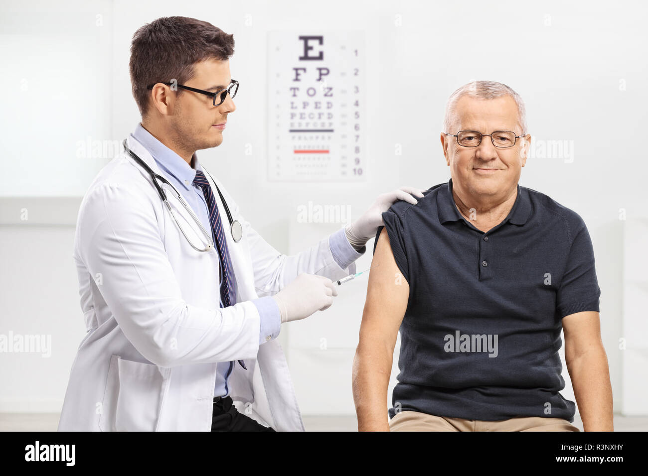 Doctor giving injection young patient hi-res stock photography and ...
