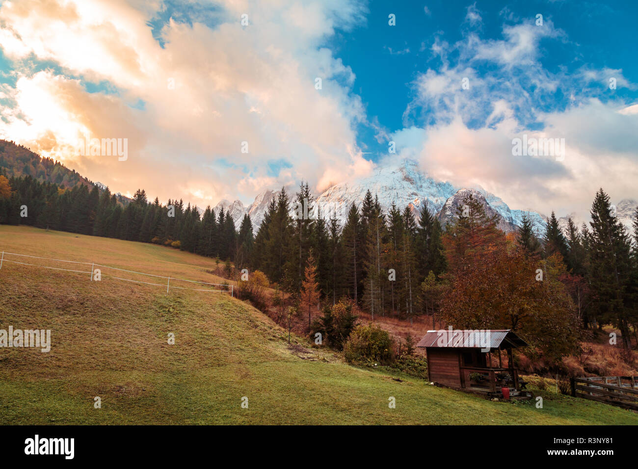 an alpine hut in the valley during a colorful sunrise Stock Photo - Alamy