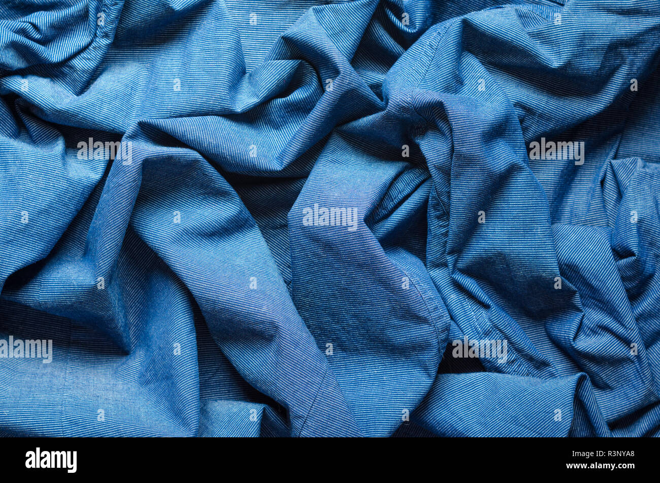 Wrinkled texture of blue fabric for shirts. Blank textile background ...