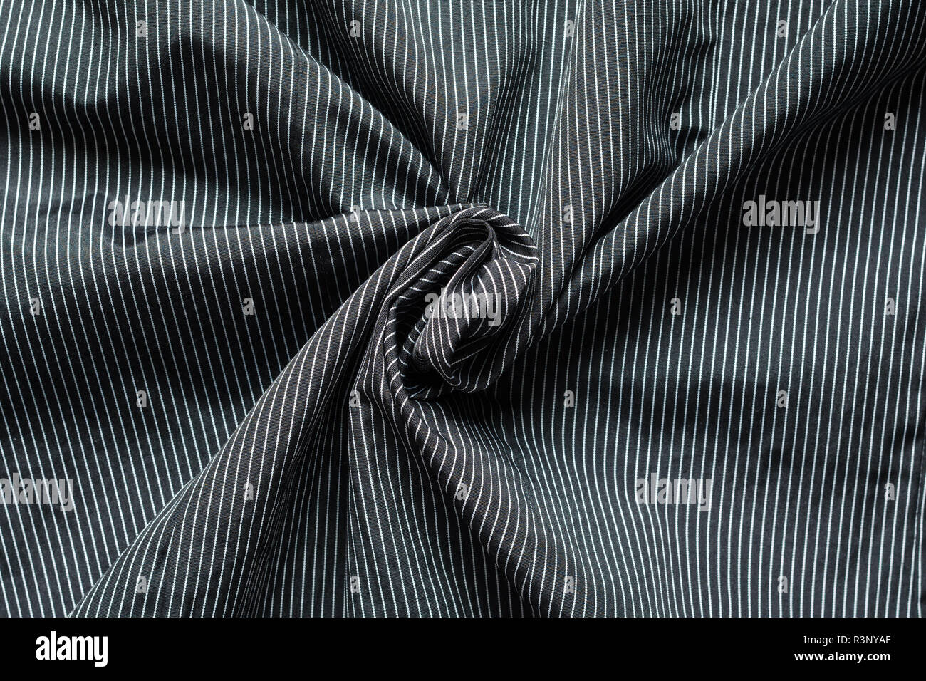 Texture of black cloth with narrow white vertical lines. Twisted in the ...