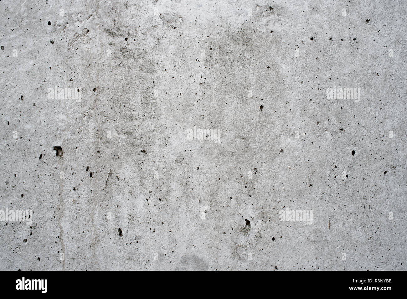 An area of coarse concrete in gray with a lot of texture fills the ...