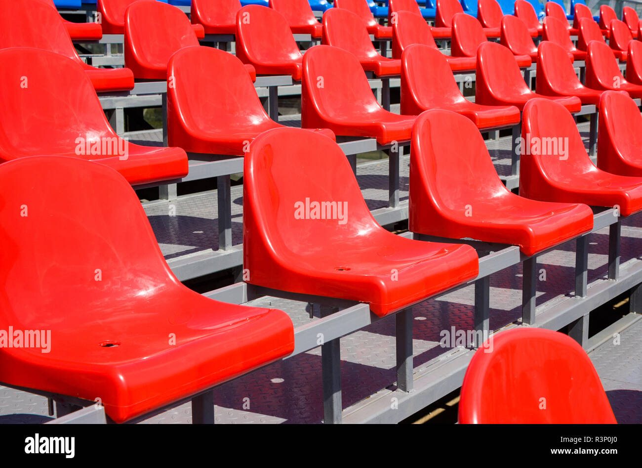 Plastic seats on stadium in summer Stock Photo - Alamy