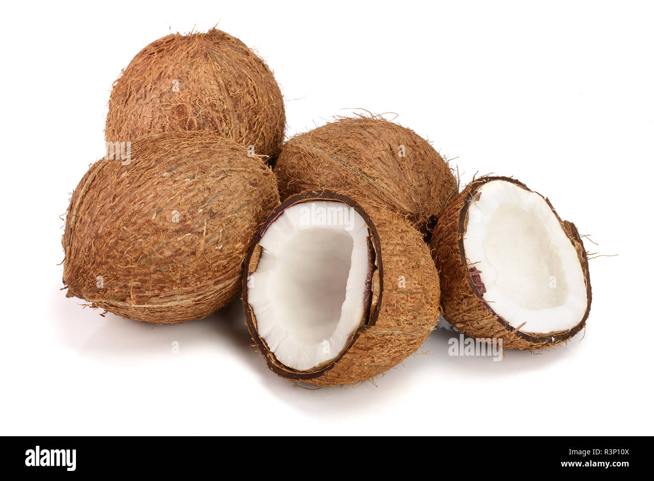 three whole coconut and two half isolated on white background Stock ...