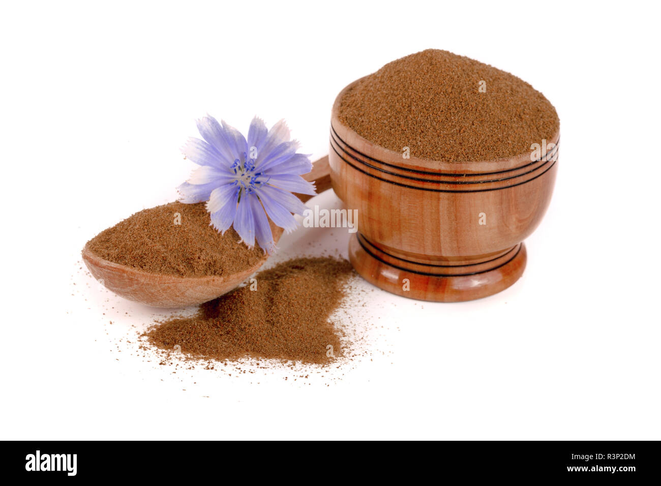 chicory powder in a bowl and spoon with a flower isolated on white ...