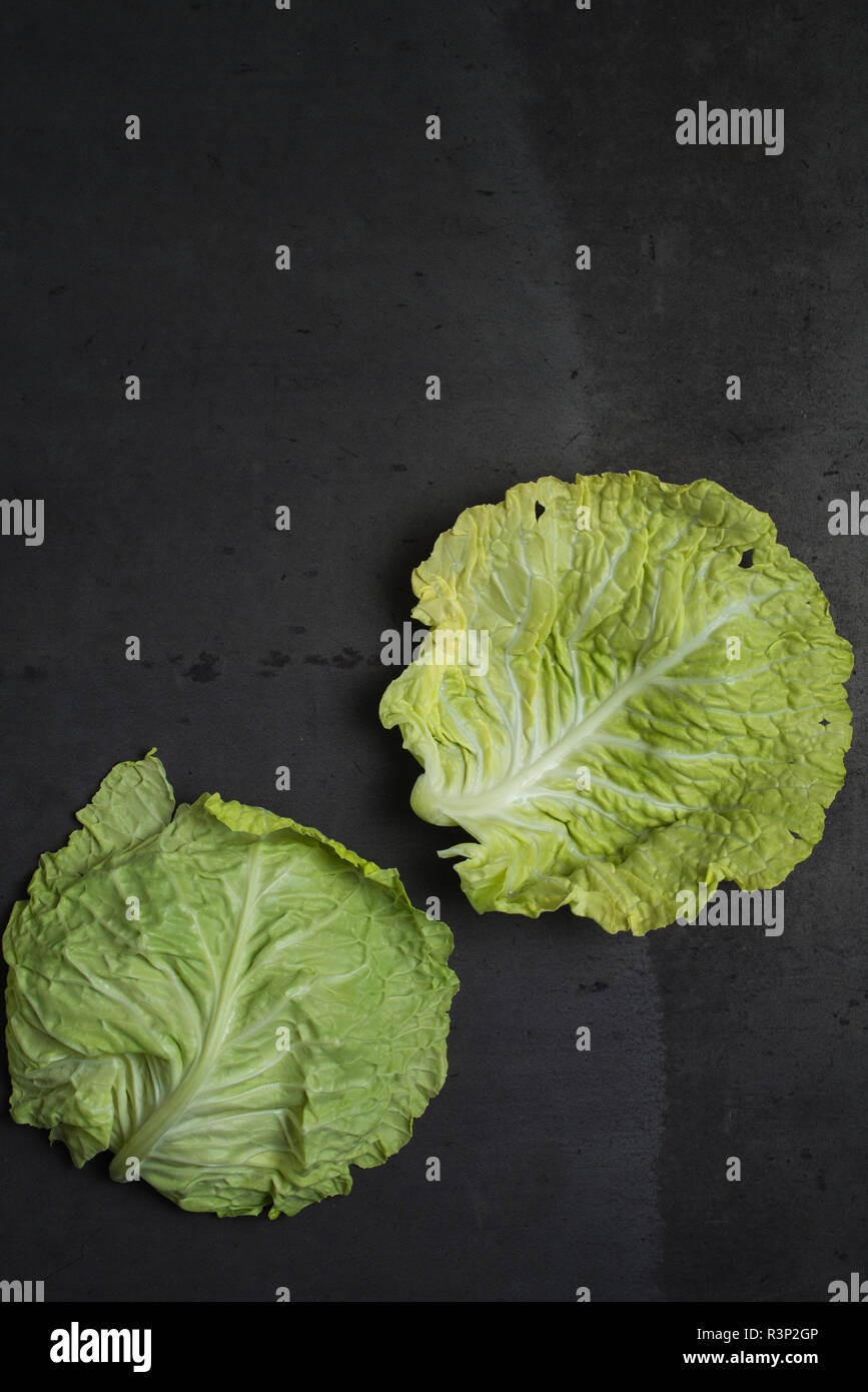 Cabbage leaves on dark gray concrete background Stock Photo - Alamy