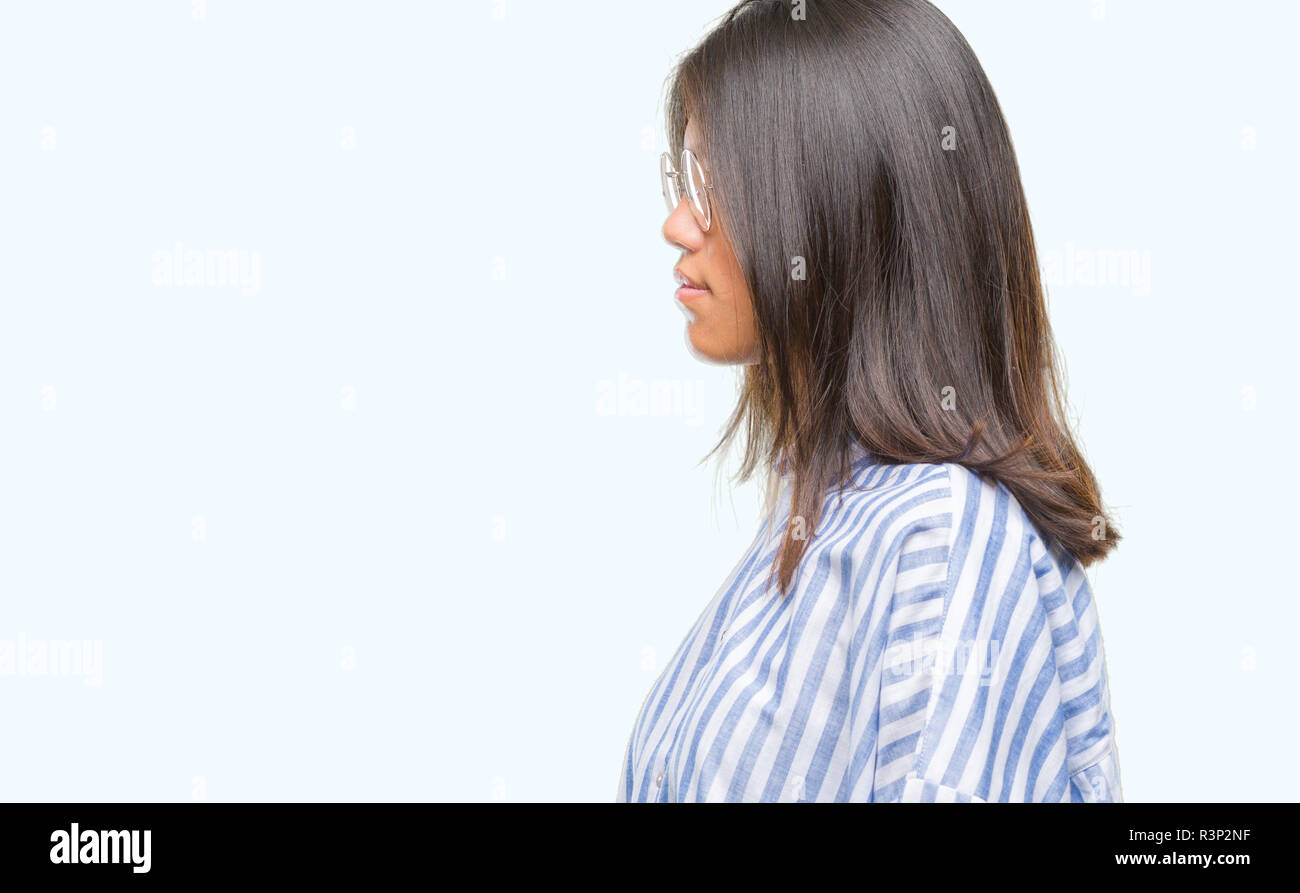 Young asian woman over isolated background looking to side, relax ...