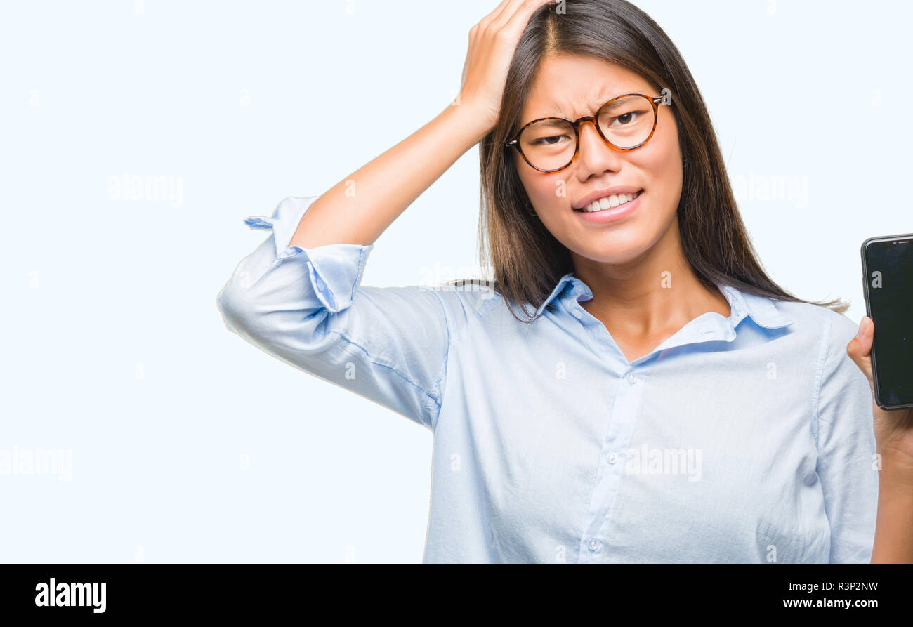 Young asian woman showing smartphone blank screen over isolated ...