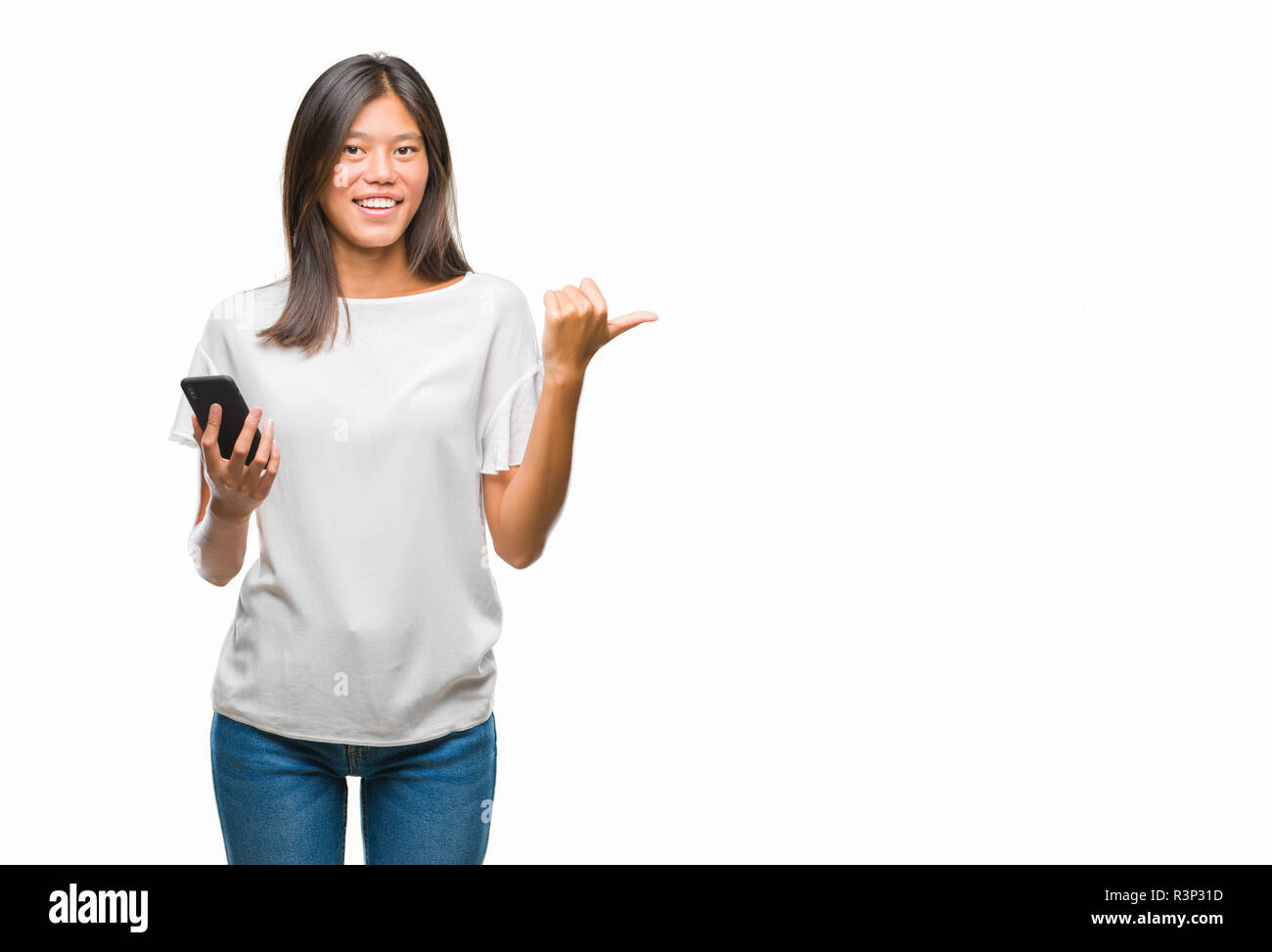 Young asian woman texting using smartphone over isolated background ...