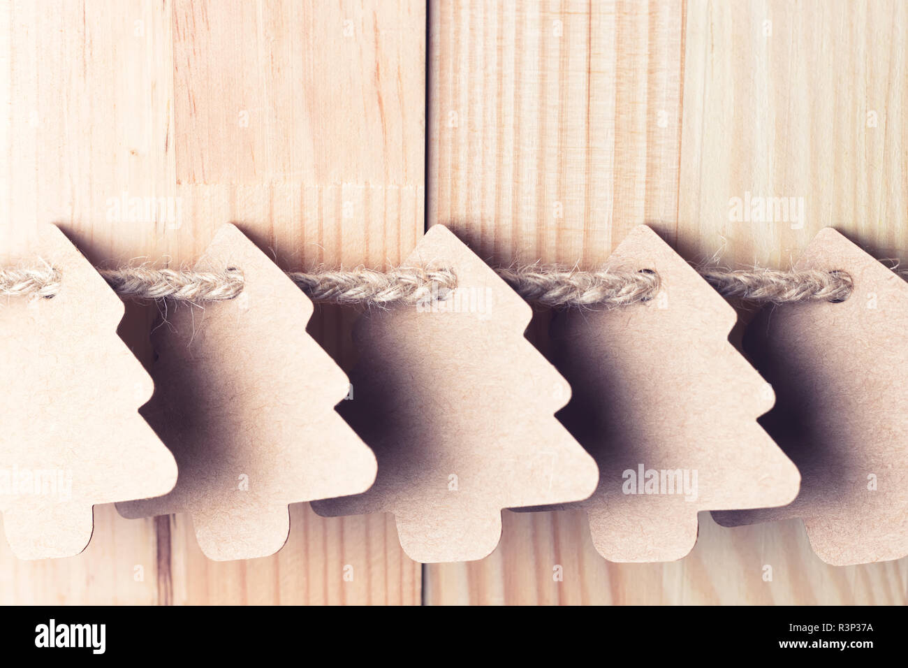 Christmas pine tree present labels on a twine on natural wooden ...