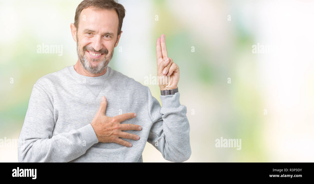 Handsome middle age senior man wearing a sweatshirt over isolated ...