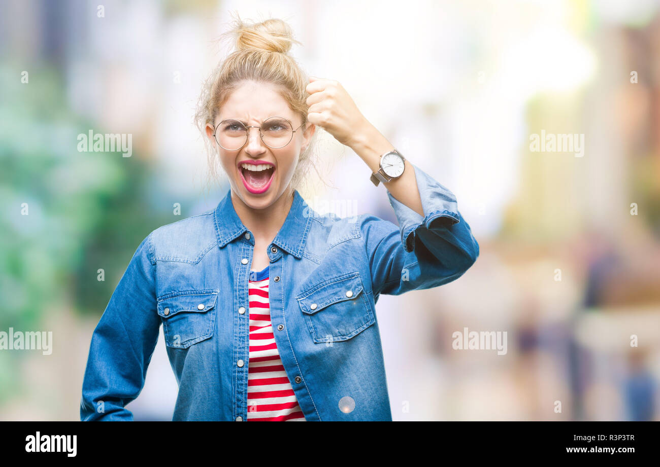 Young beautiful blonde woman wearing glasses over isolated background ...