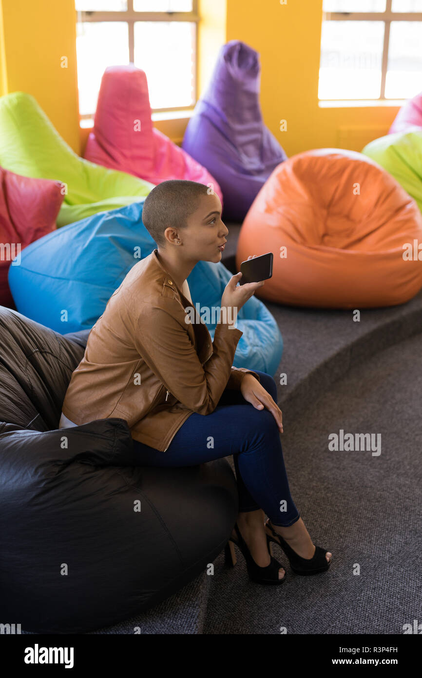 Woman sitting on bean bag hi-res stock photography and images - Alamy
