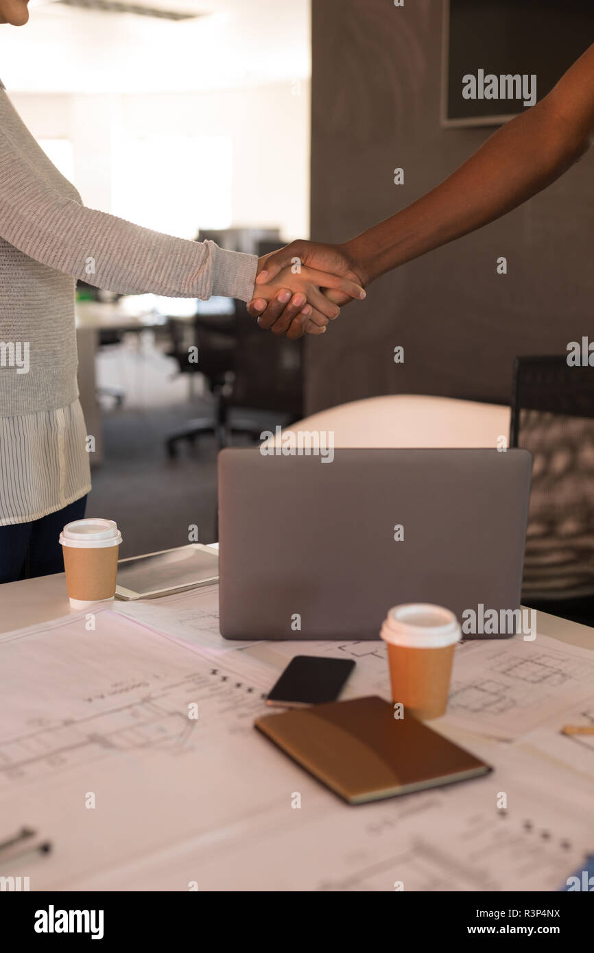 Executive shaking hands in office Stock Photo - Alamy