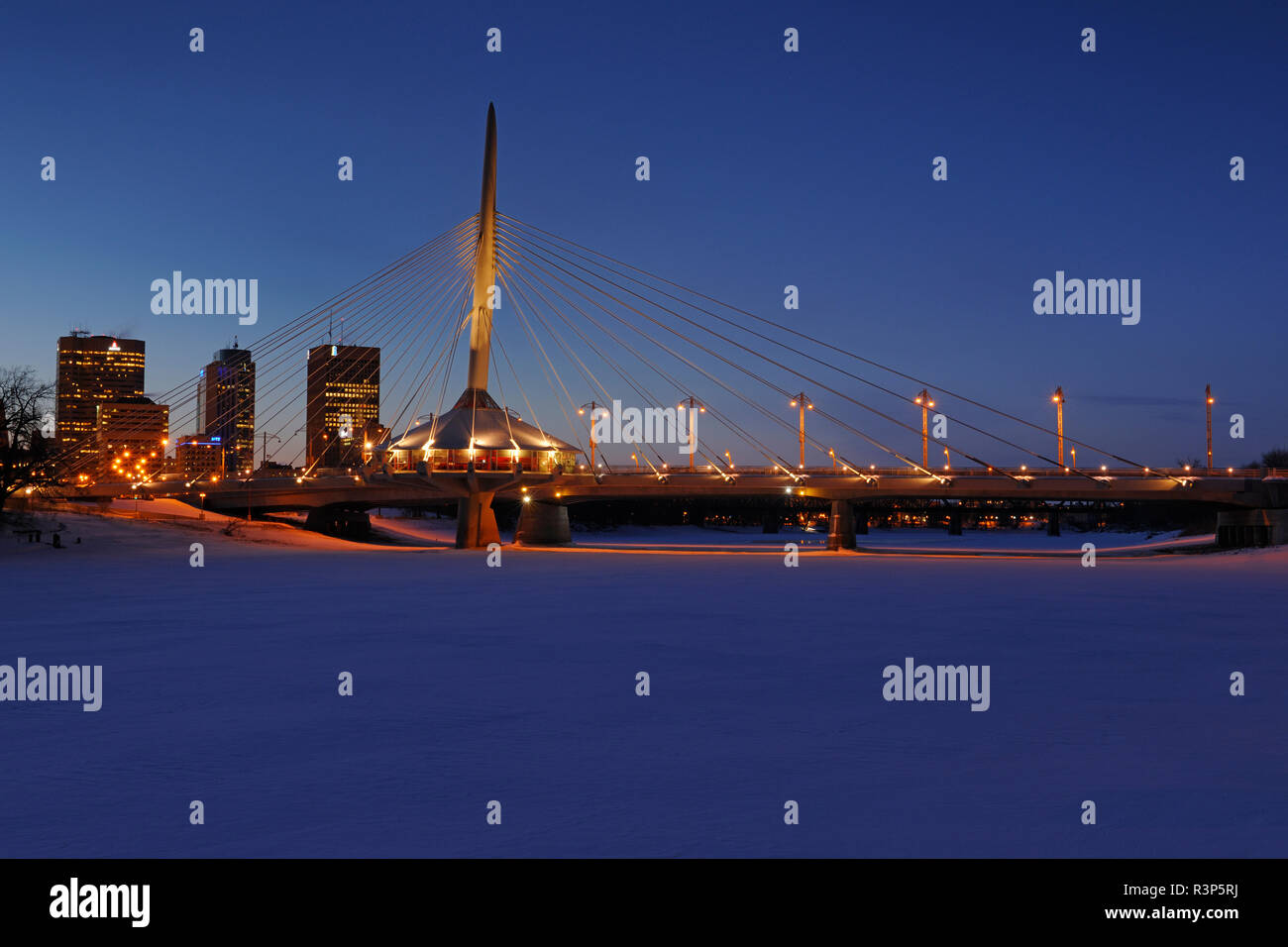 Canada, Manitoba, Winnipeg. Winter skyline and Esplanade Riel Bridge at ...