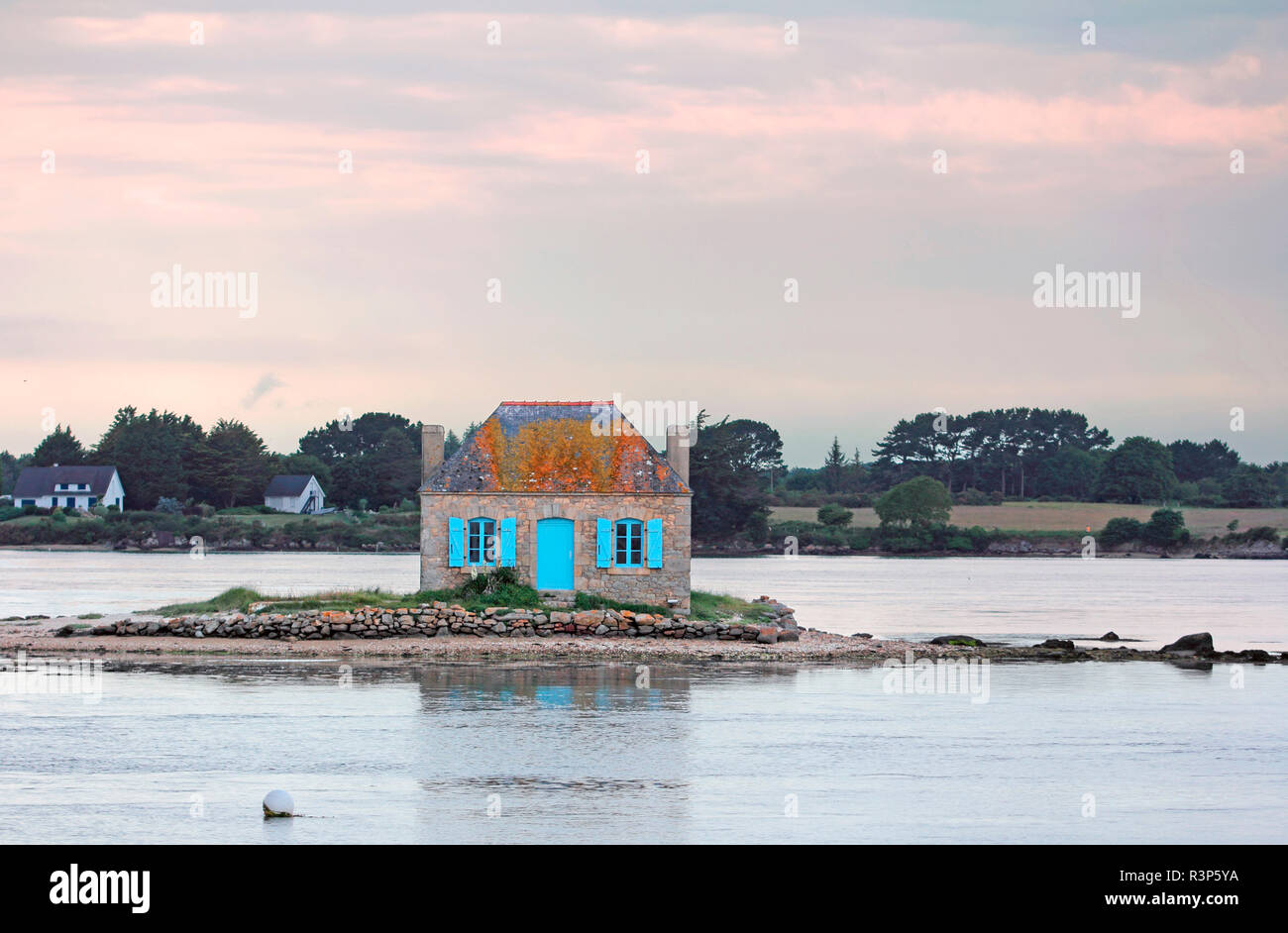 Old oyster park guard house at dusk, Ria (estuary) of Etel river ...