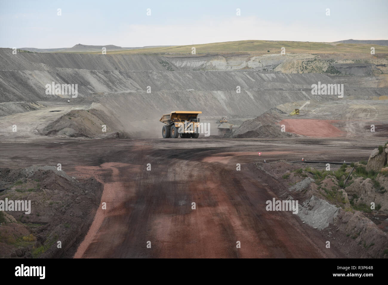 Coal mining industry, coal hauler truck inside of a massive open pit ...