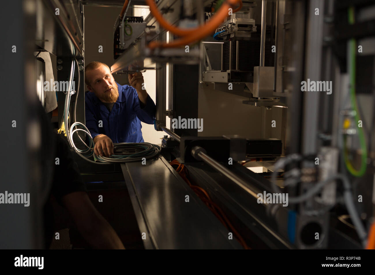 Robotic engineer working in warehouse Stock Photo - Alamy