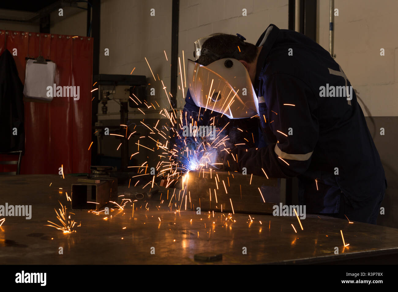 Robotic engineers using welding torch Stock Photo - Alamy