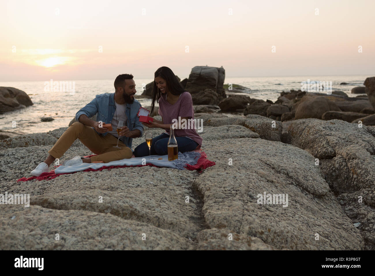 Beautiful couple smiling sitting near hi-res stock photography and images - Alamy