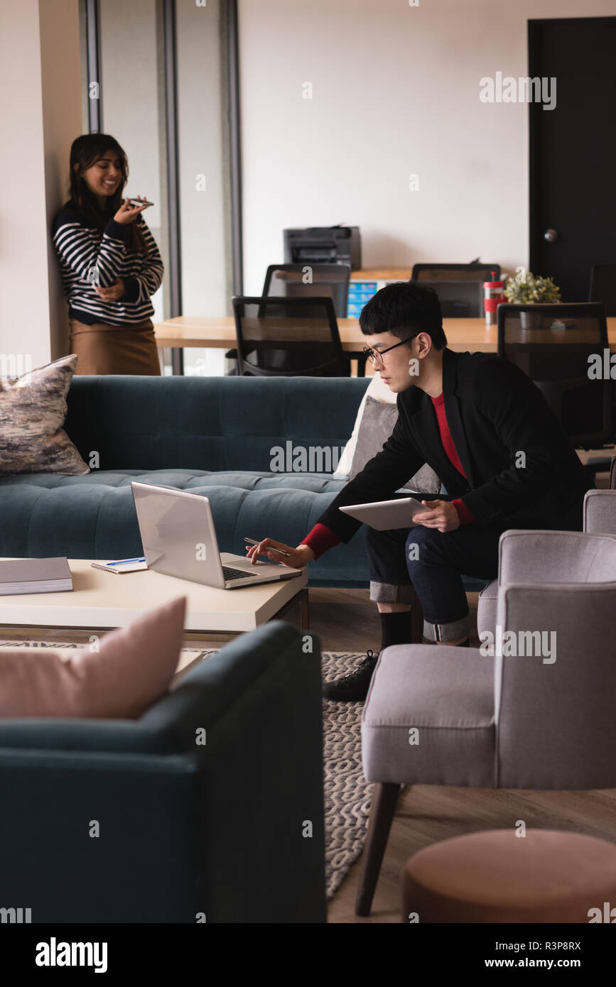 Executive using laptop in office Stock Photo - Alamy