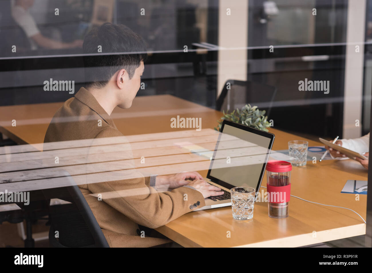 Executive using laptop in office Stock Photo - Alamy