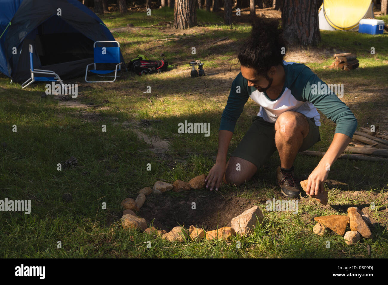 Man preparing bonfire in the forest Stock Photo - Alamy