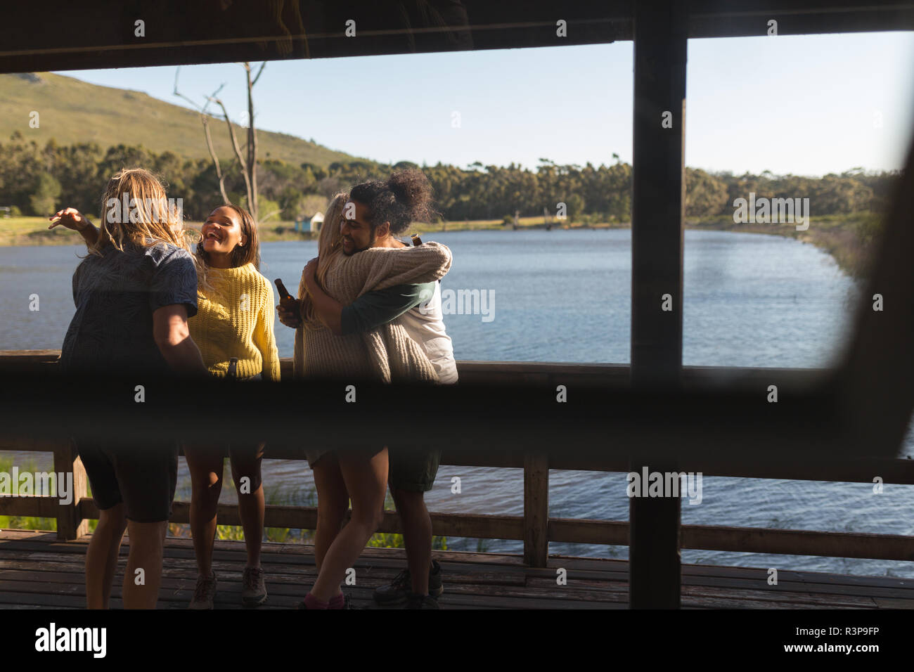 Friends hugging each other in cabin Stock Photo - Alamy