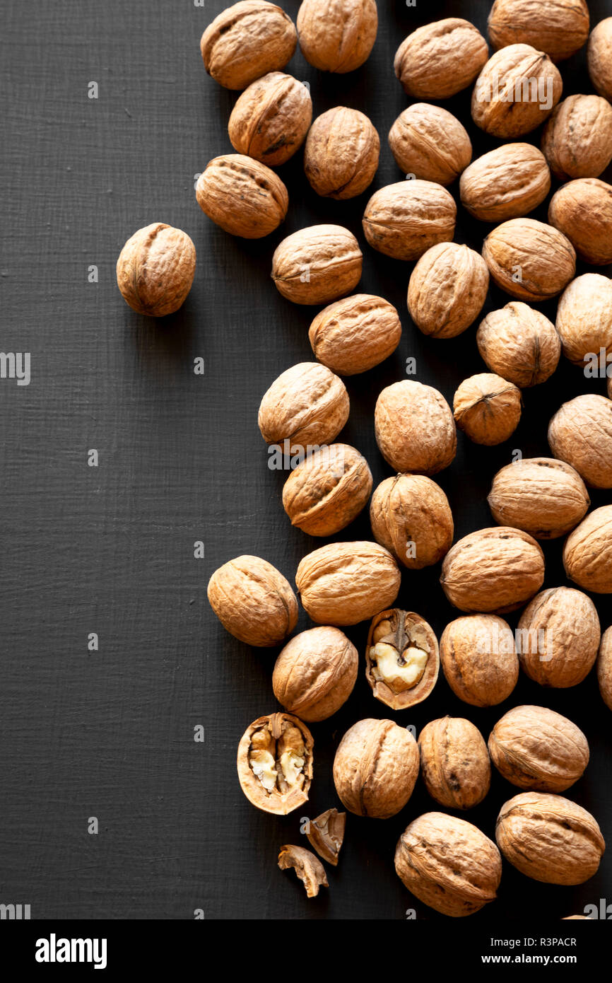 Many walnuts on black background, top view. From above, overhead Stock ...