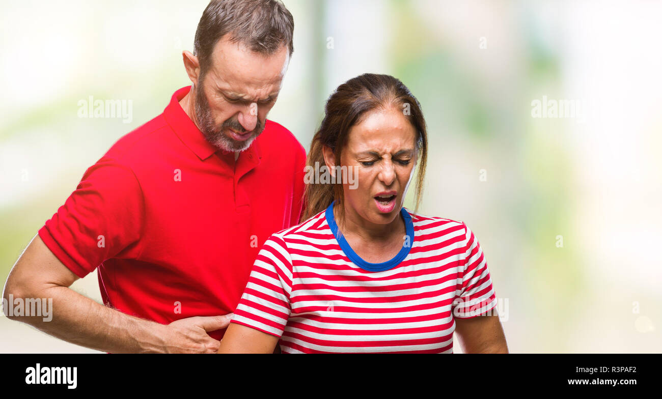 Middle age hispanic couple in love over isolated background with hand ...