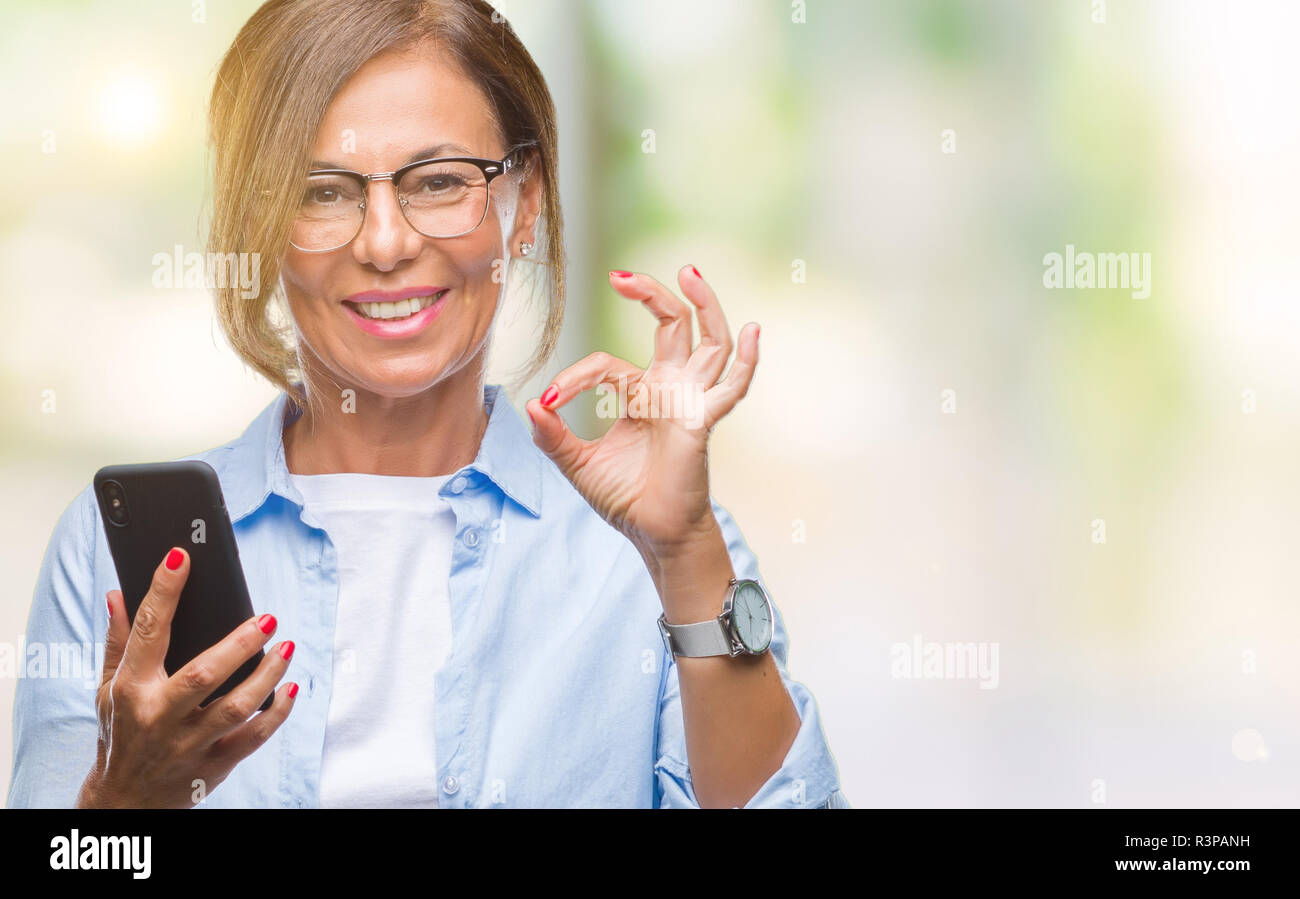 Middle age senior woman texting sending message using smartphone over ...