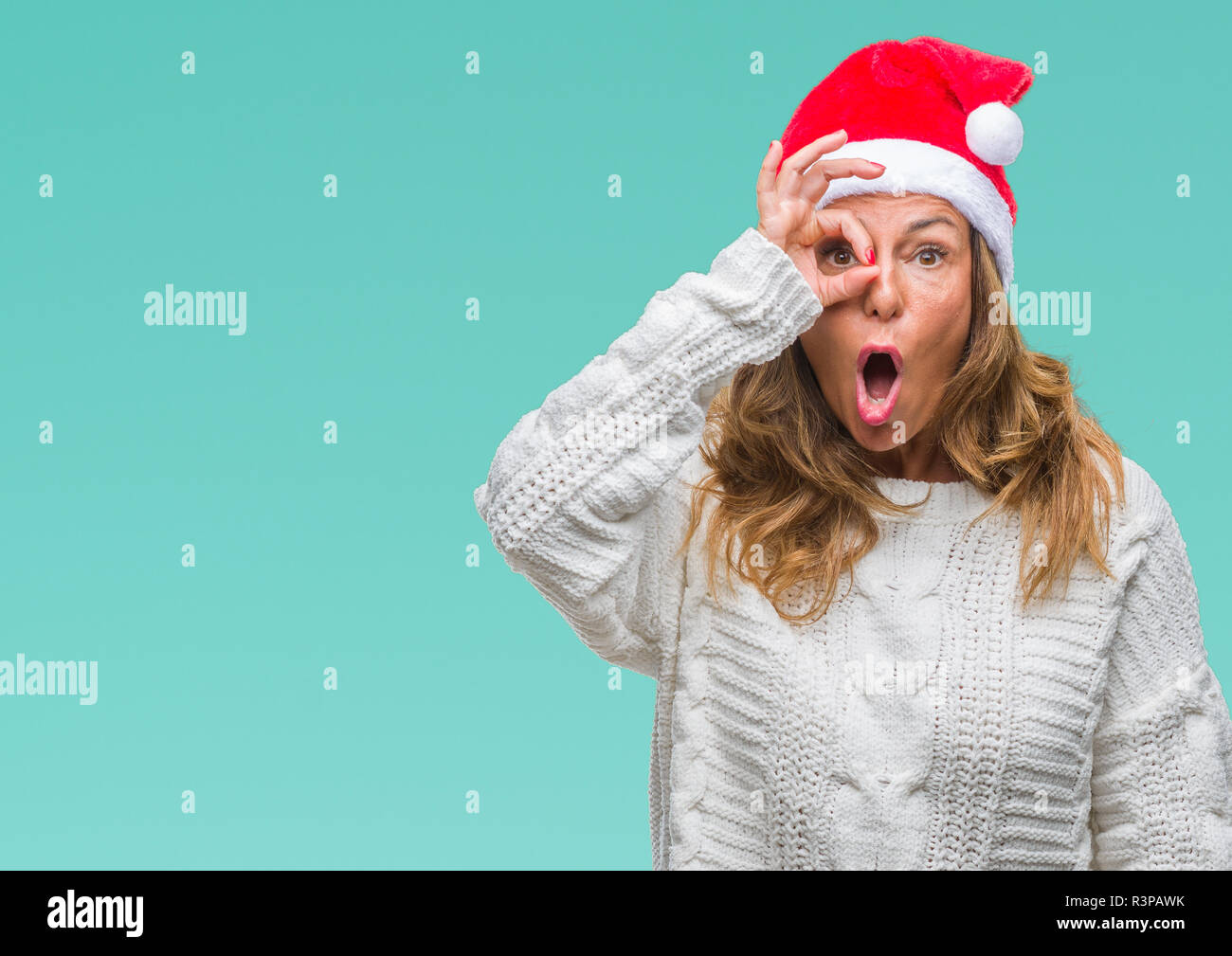 Middle Age Senior Hispanic Woman Wearing Christmas Hat Over Isolated