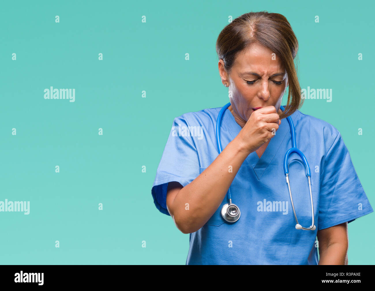 Middle age senior nurse doctor woman over isolated background feeling ...