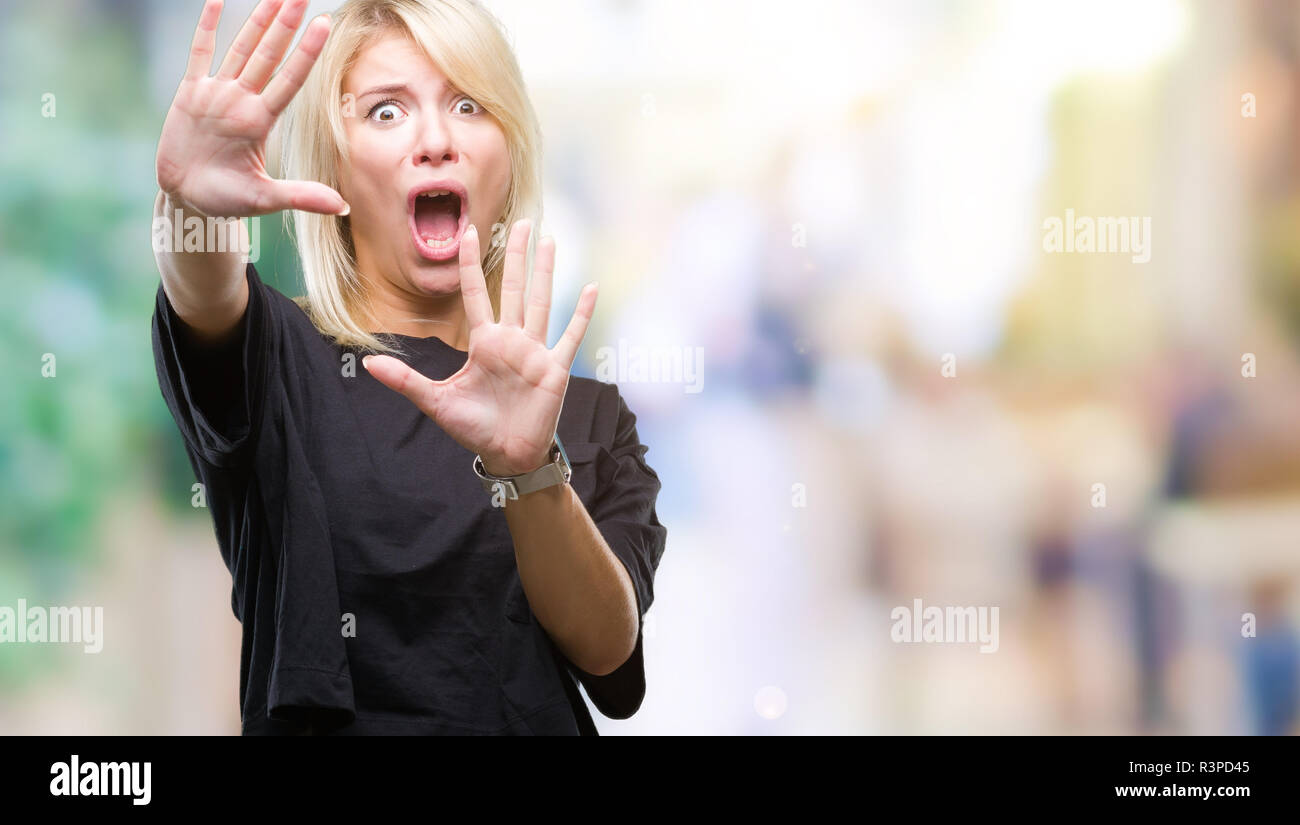 Young beautiful blonde woman over isolated background afraid and ...