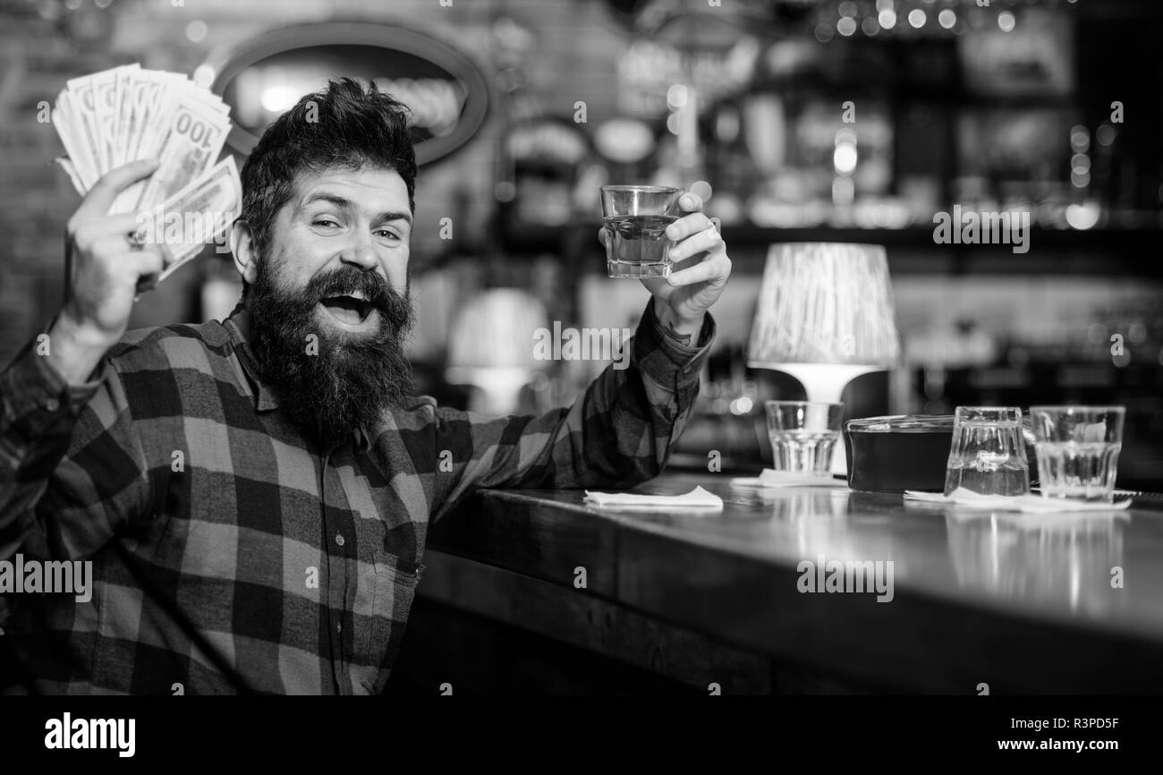 Alcohol drinks concept. Man with drunk face sit alone at bar counter ...